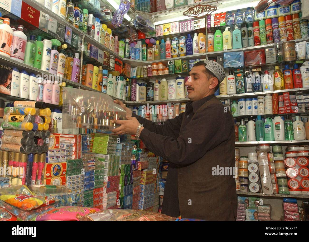 Pakistani shopkeeper Mauladad Khan arranges Iranian smuggled items in ...