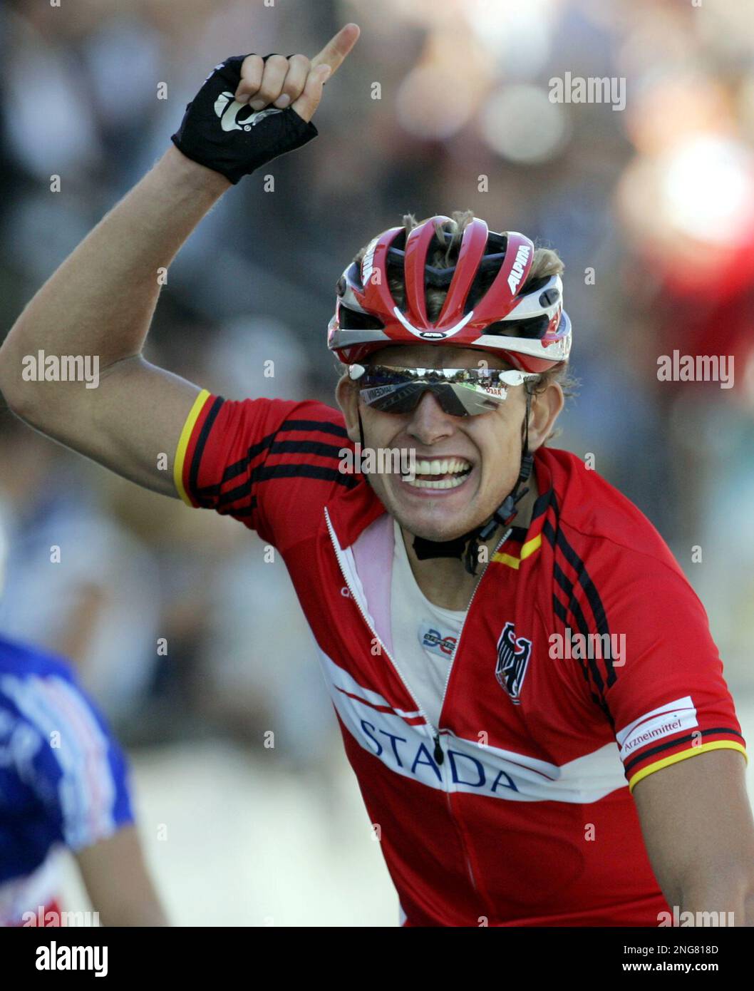 Gerald Ciolek of Germany celebrates as he crosses the finish line to ...