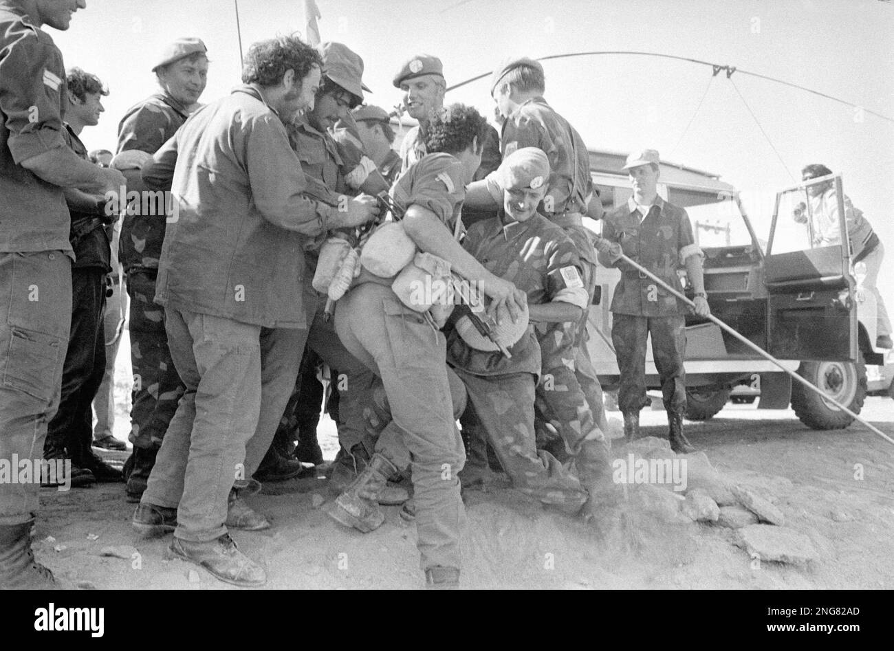 Israeli troops, foreground, and United Nations peace-keeping forces, in ...