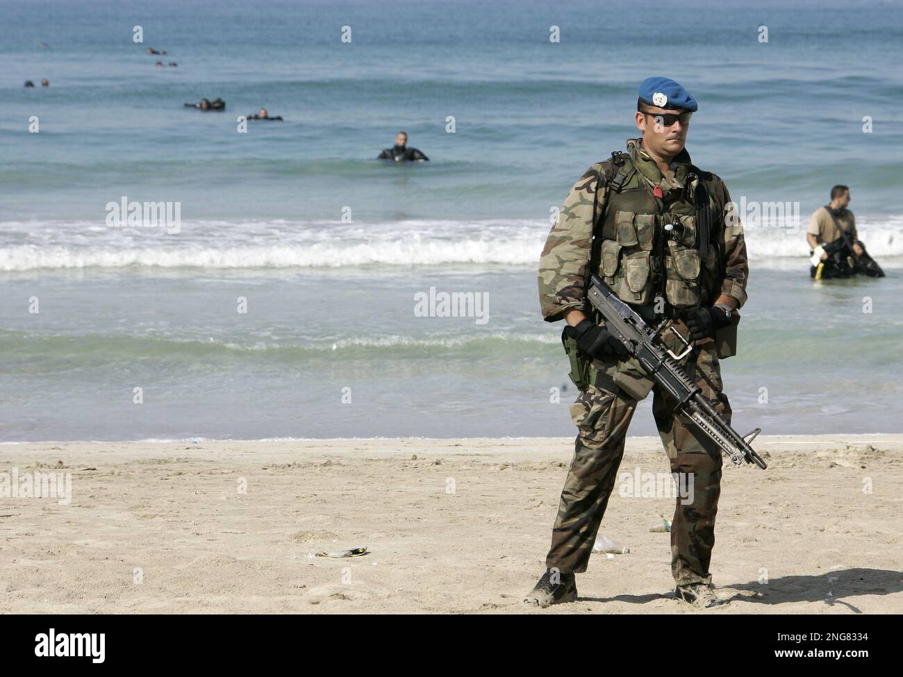 A Spanish UNIFIL soldier holding a M60 machine gun stands guard as ...