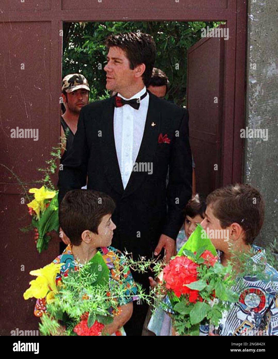 FILE-Albanian gang leader Zani wears formal dress outside a polling ...