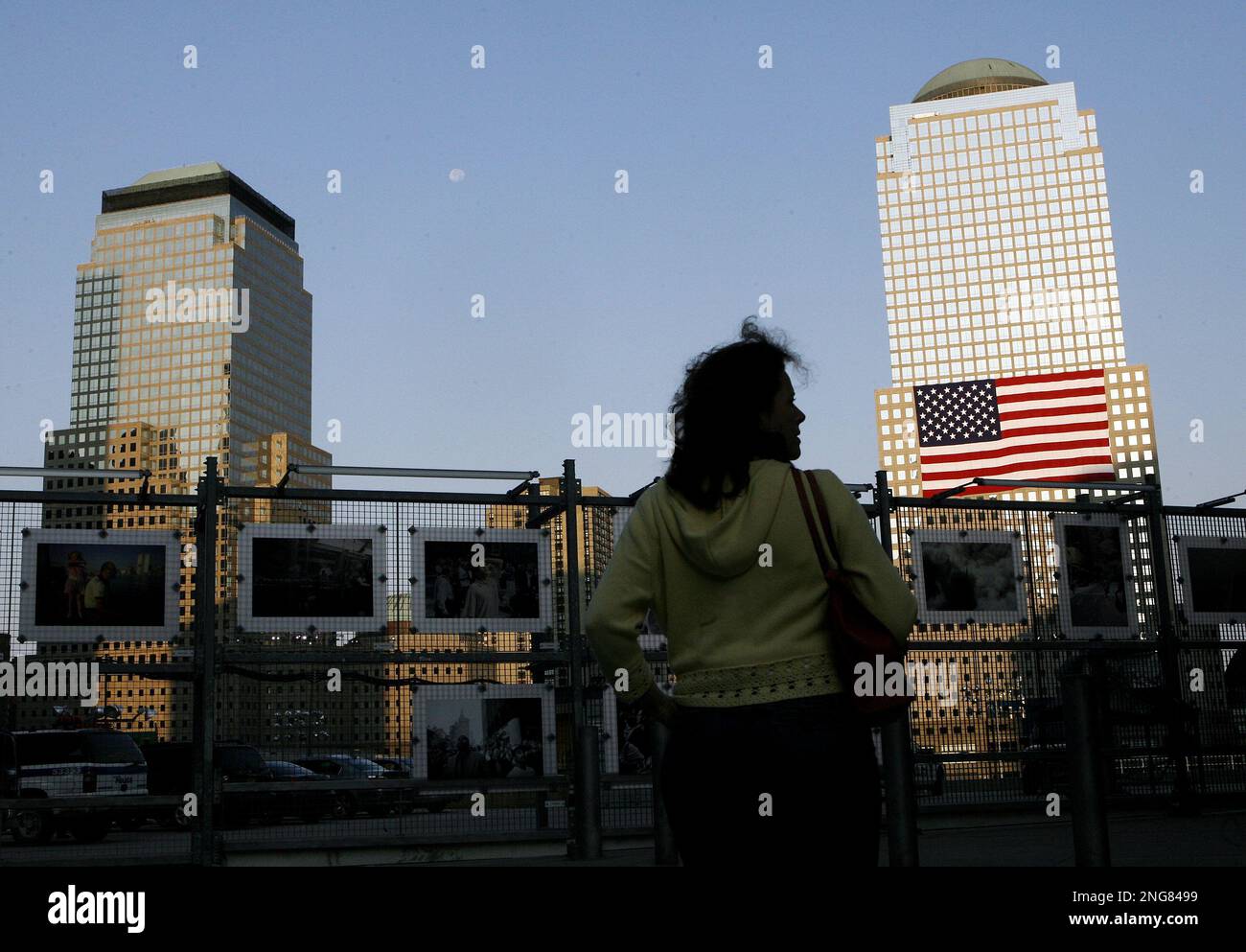A commuter stops by the fence at the WTC site to look at the ...