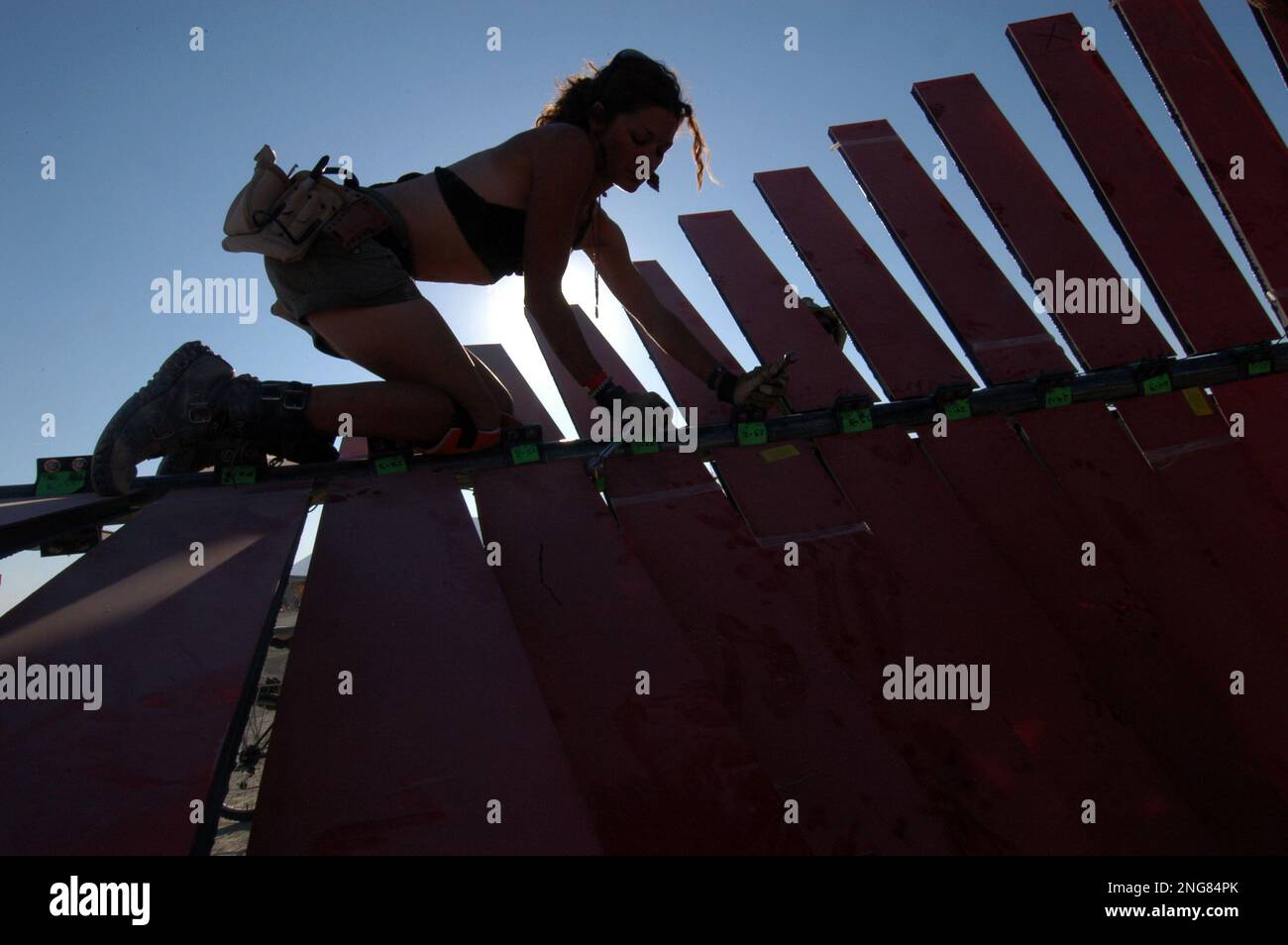 New York City artist Kate Raudenbush tightens bolts on her sculpture at ...