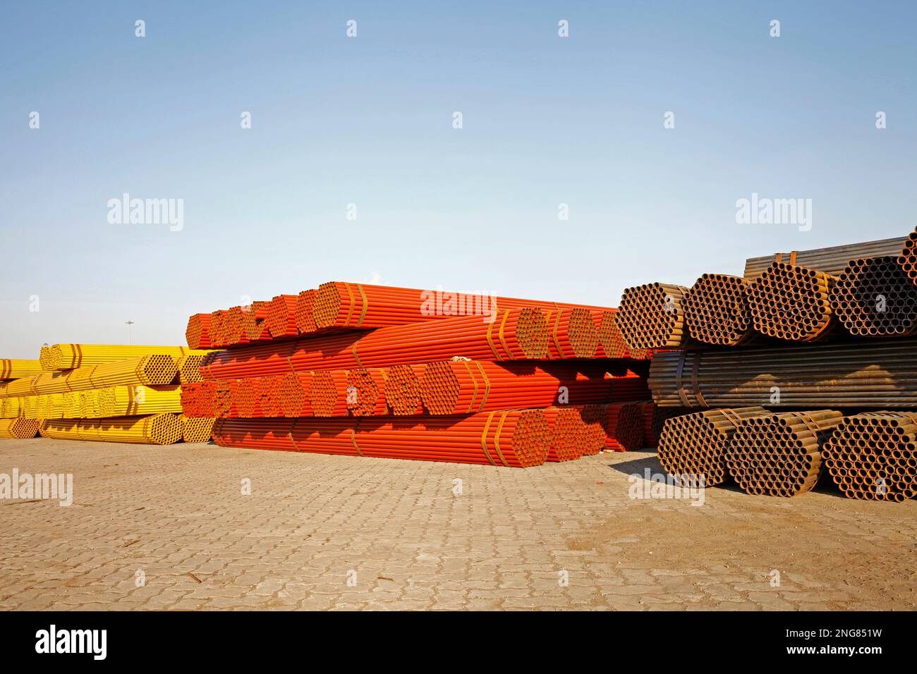 Red stacked steel pipe Stock Photo - Alamy