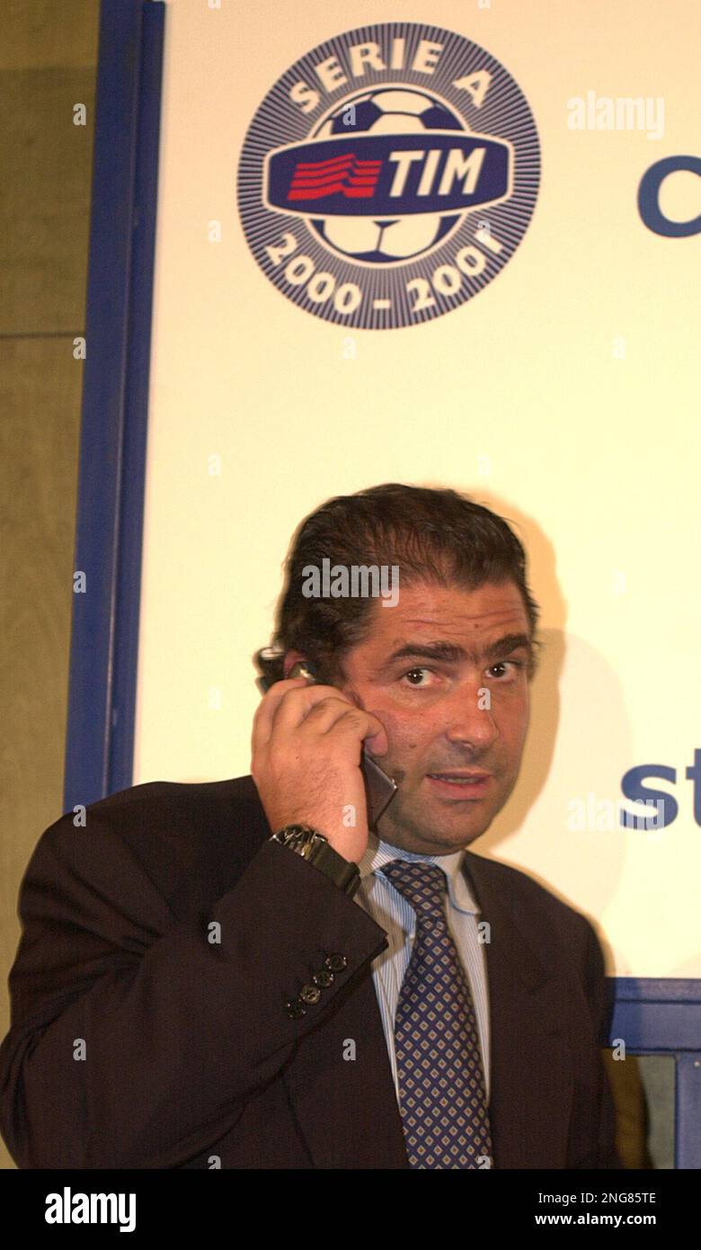 Marco De Benedetti, managing director of TIM uses his mobile phone as ...