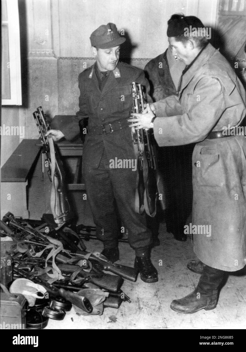 One of 45 Hungarian freedom fighters hands over his weapon to an ...
