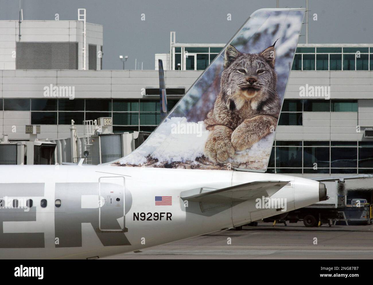 The tail of a Frontier Airlines Airbus 320 is shown as the plane heads ...