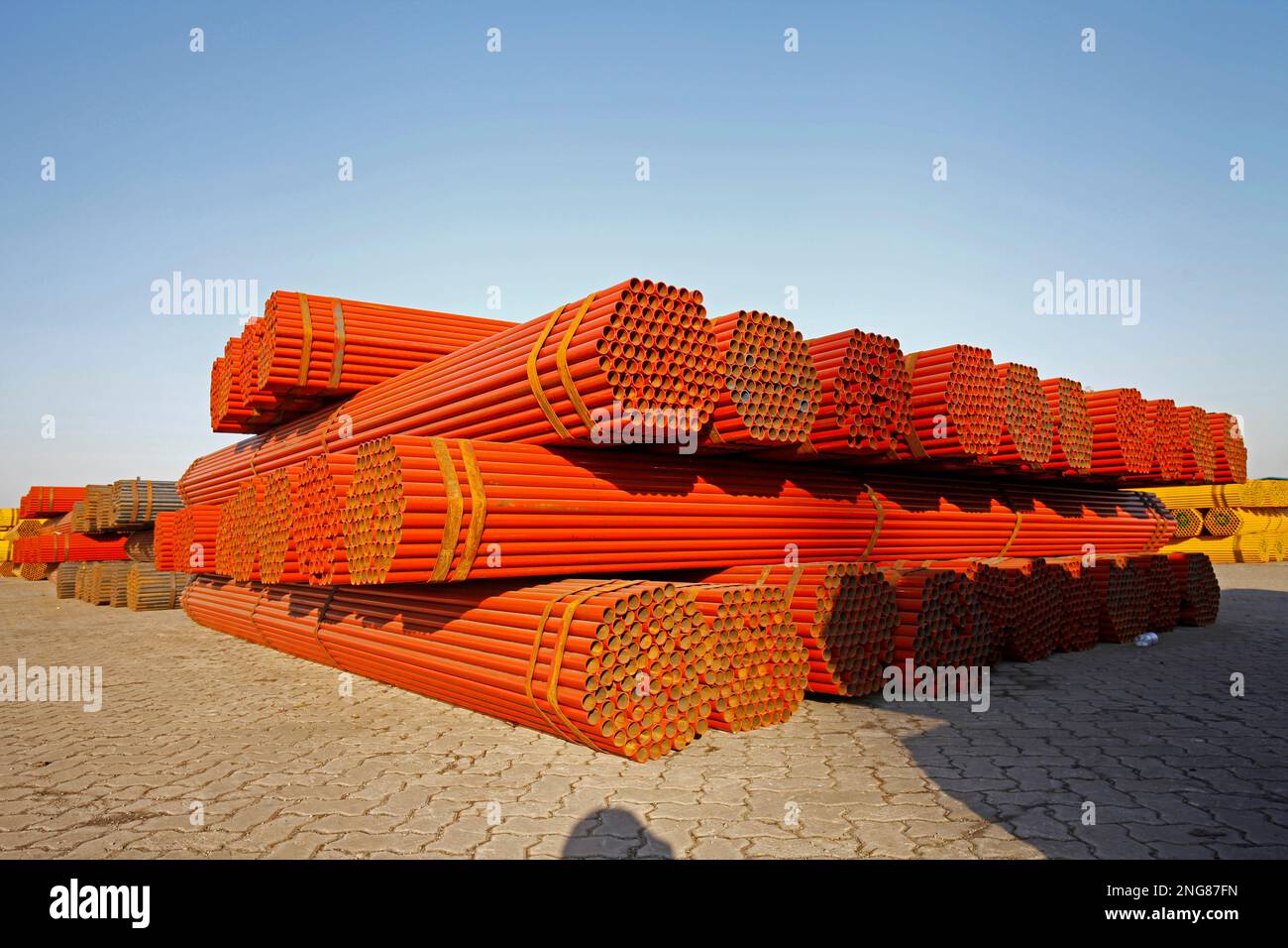 Red stacked steel pipe Stock Photo - Alamy