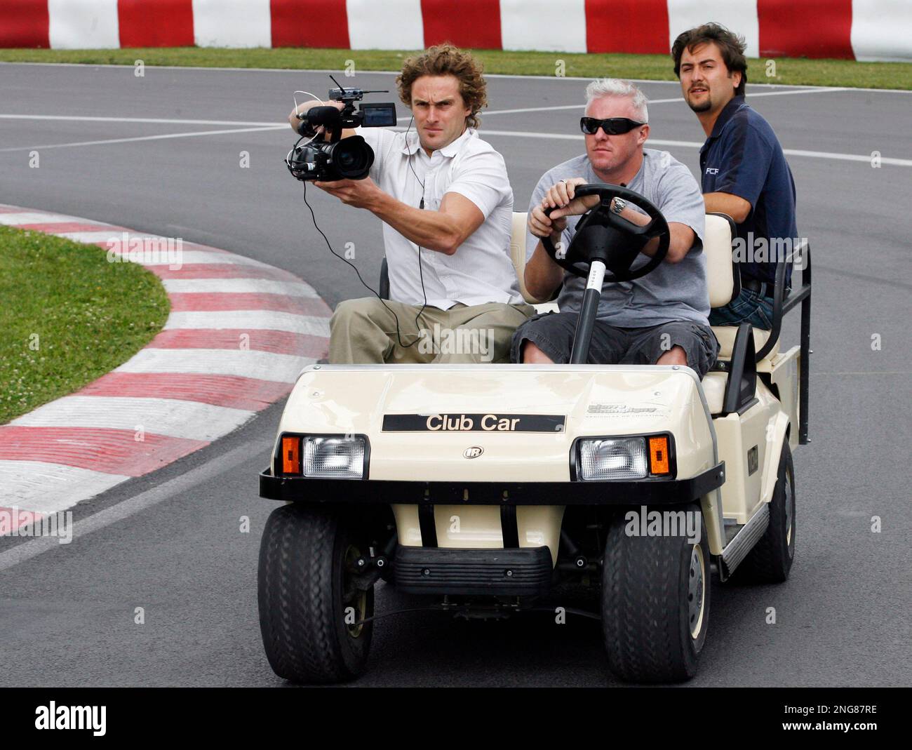 Forsythe Racing driver Paul Tracy, from Canada drives a golf cart ...