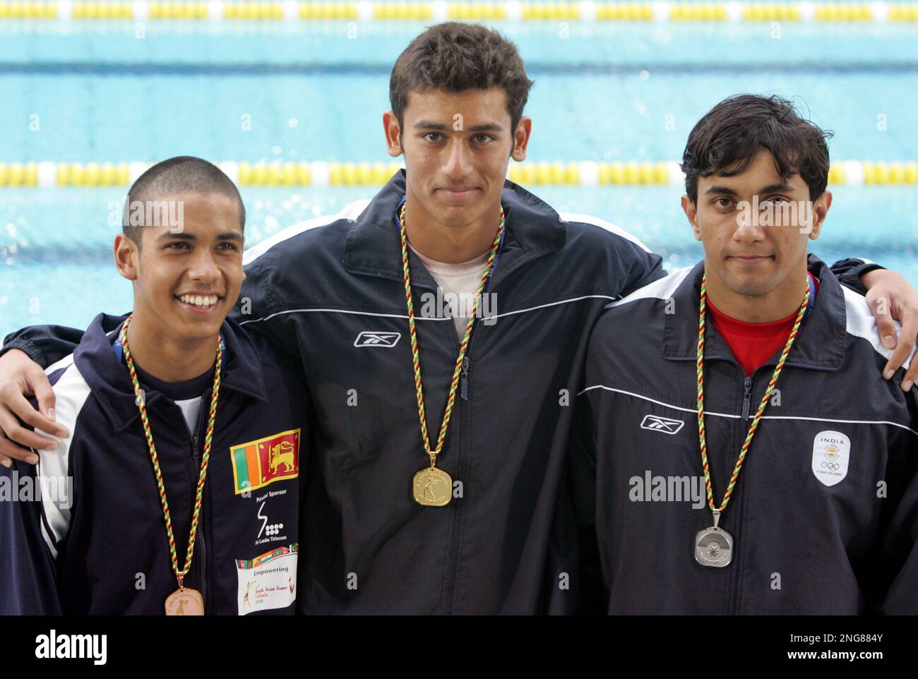 India's gold winner Virdhaval Khade, center, silver winner Amar ...