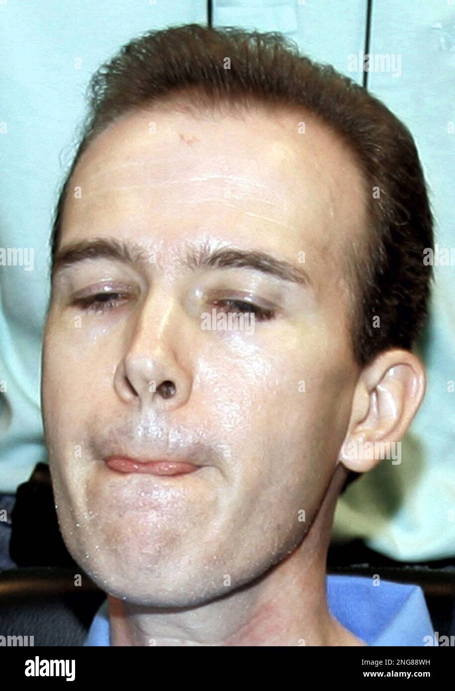 Murder suspect John Mark Karr licks lips during a police news ...