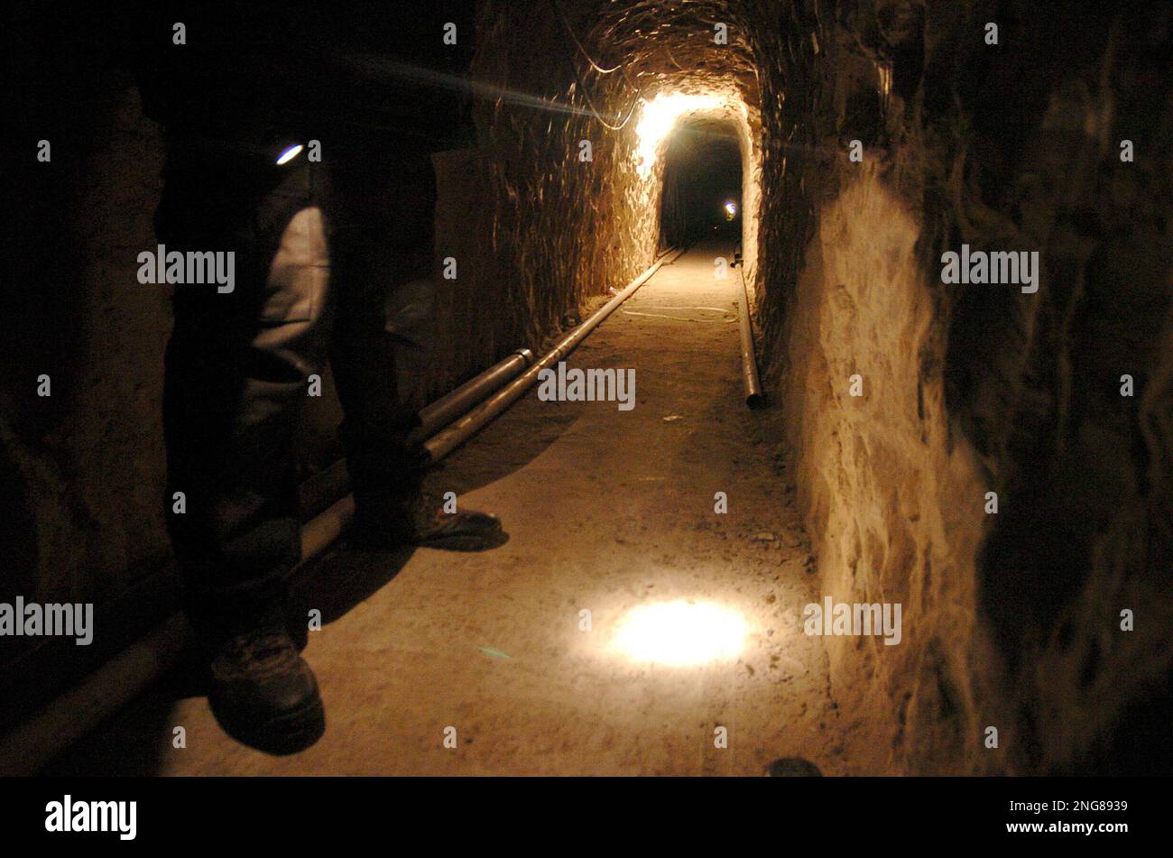 **FILE** A Mexican federal police officer shines his flashlight on the ...