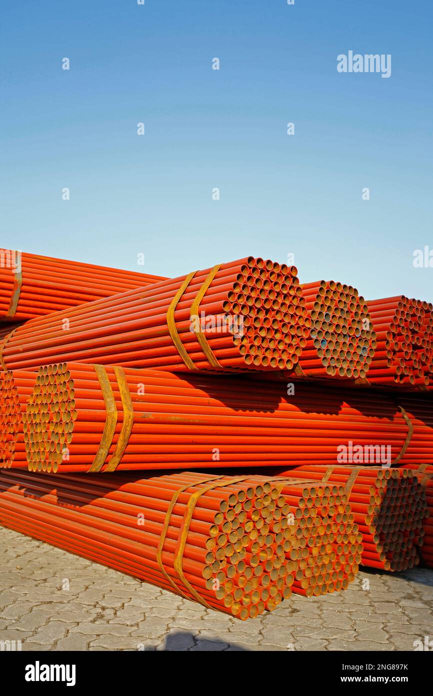 Red stacked steel pipe Stock Photo - Alamy