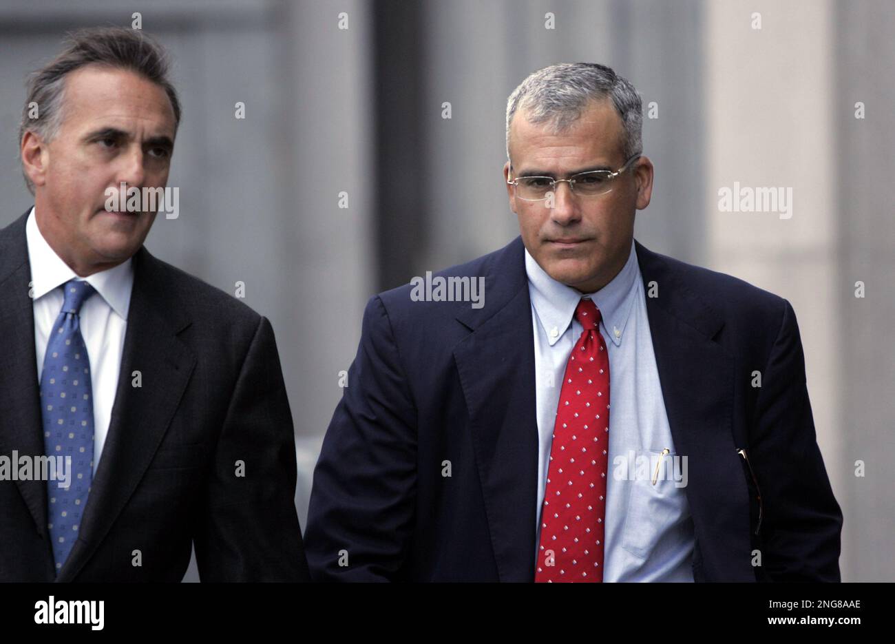 Brocade's former CEO Gregory L. Reyes, right, walks into a federal ...