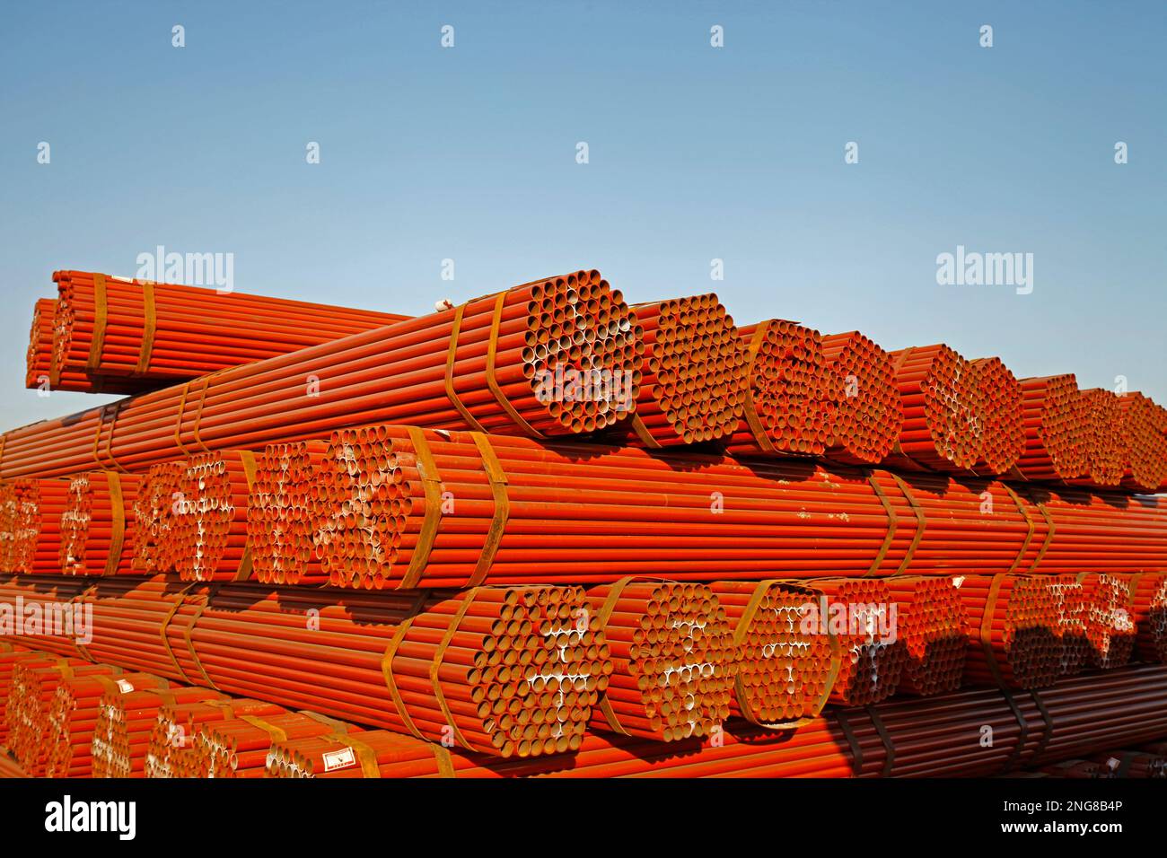Red stacked steel pipe Stock Photo - Alamy