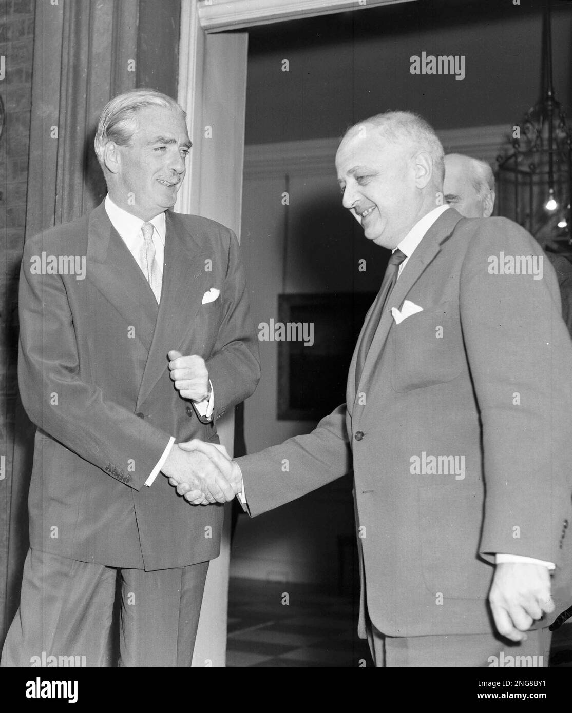 British Prime Minister Sir Anthony Eden, left, shakes hands with French ...