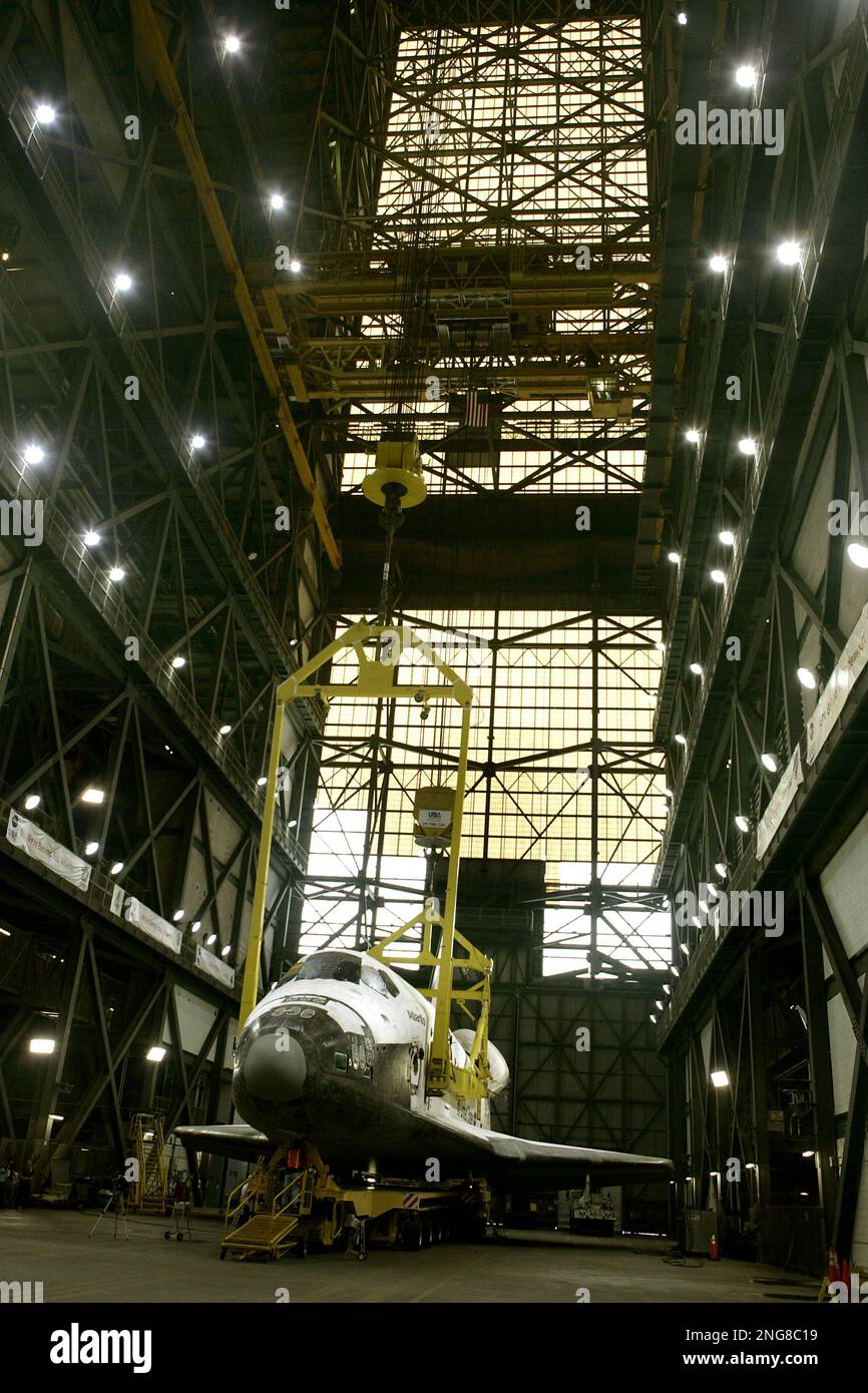 The Space Shuttle Atlantis is made ready to be lifted to a vertical ...