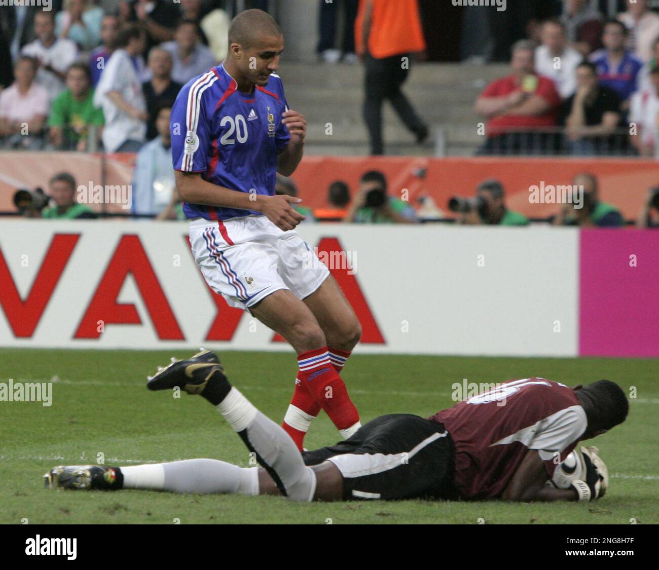 Togo's goalkeeper Kossi Agassa makes a save in front of France's David ...