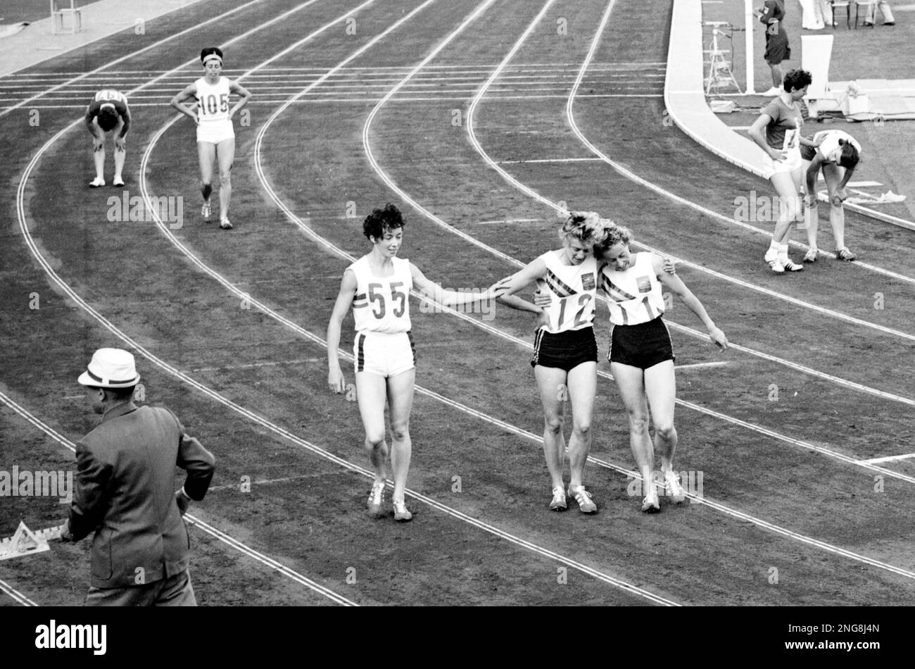 Britain's Ann Packer (55) congratulates Betty Cuthbert (12) and J.F ...