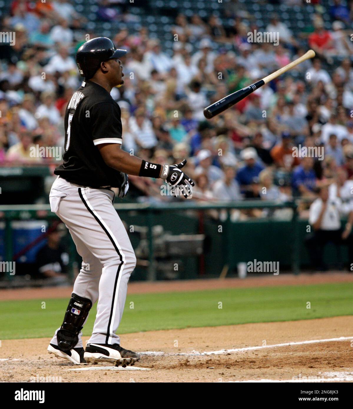 Chicago White Sox Juan Uribe flips his bat in the air after striking ...