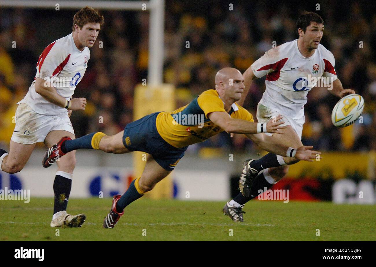 Australia's halfback Sam Cordingley passes the ball as Engalnd players ...