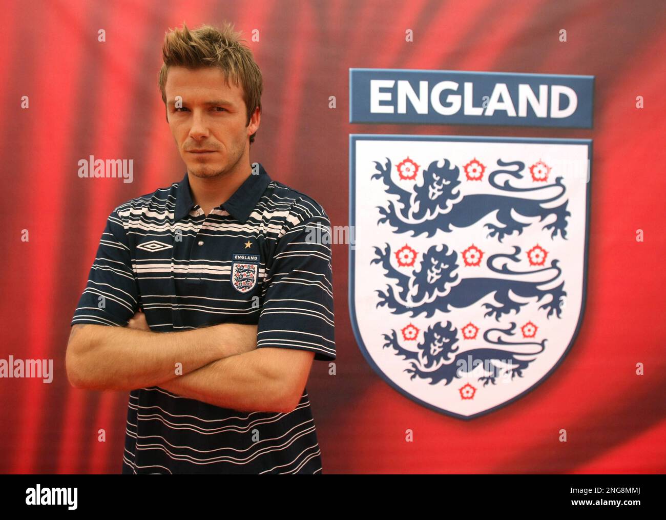 England captain David Beckham poses in front of an England badge at ...