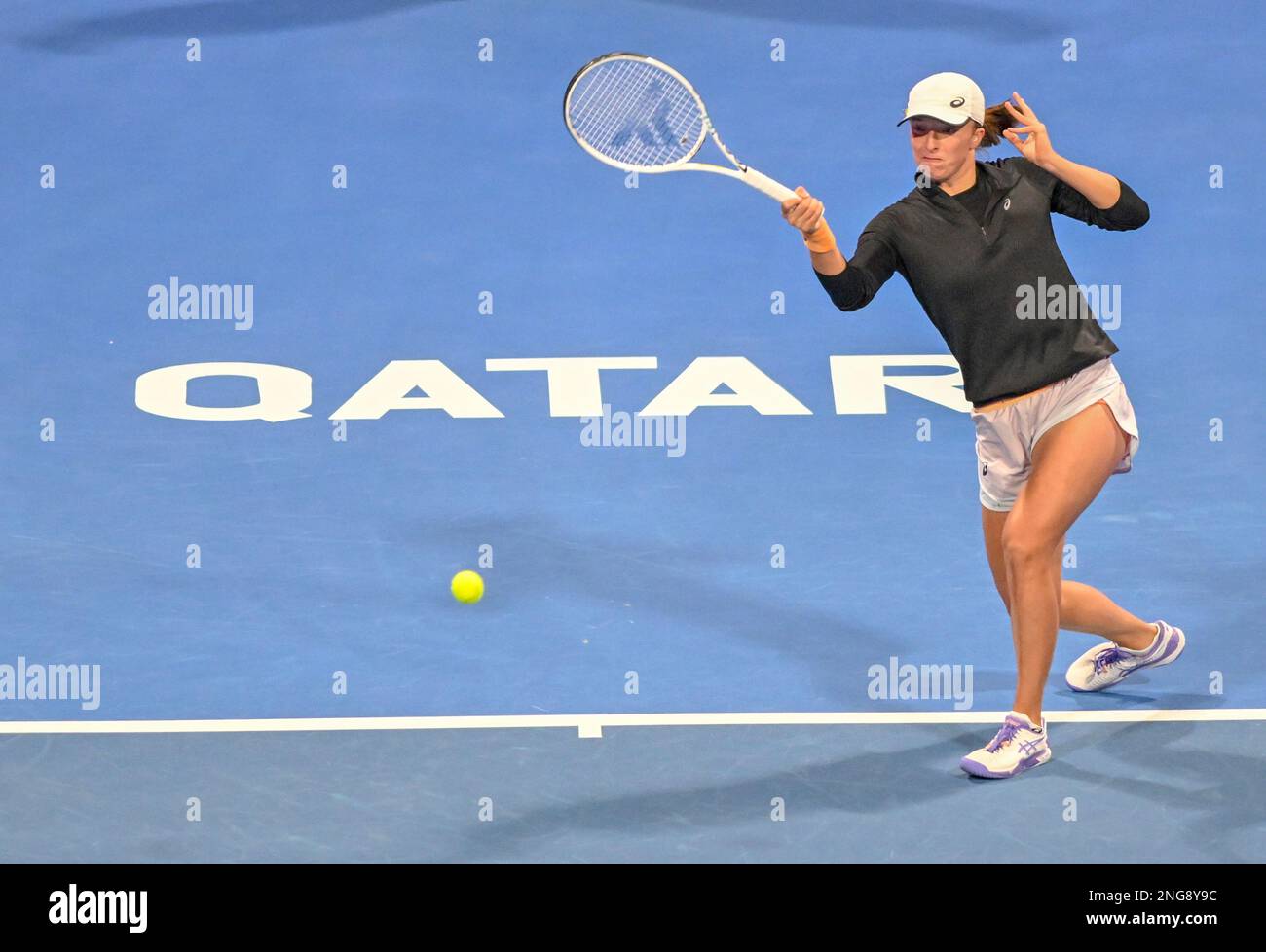 Doha, Qatar. 17th Feb, 2023. Iga Swiatek of Poland hits a return during ...