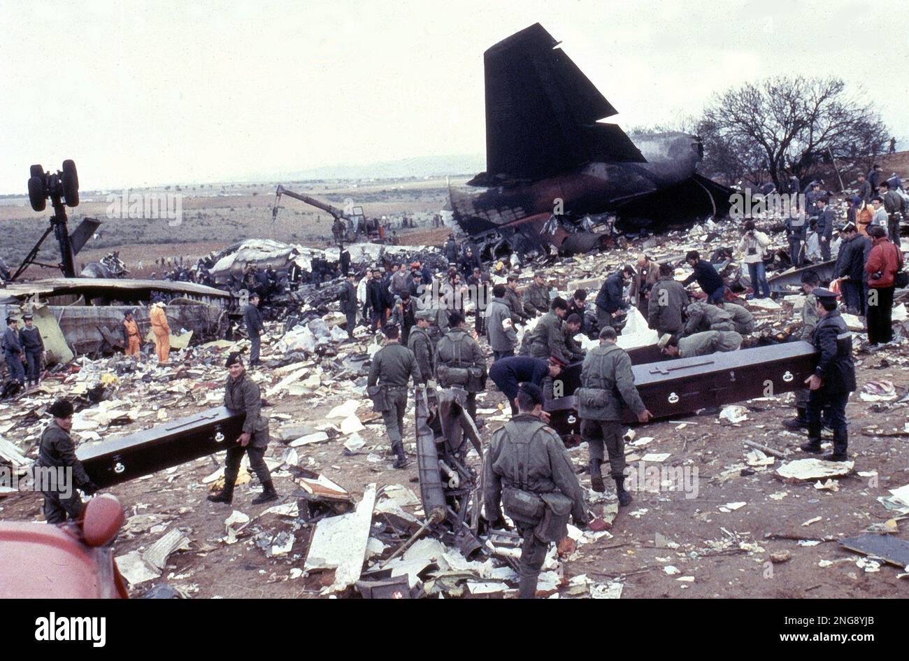 Rescue workers carry coffins at the scene of an air disaster near ...