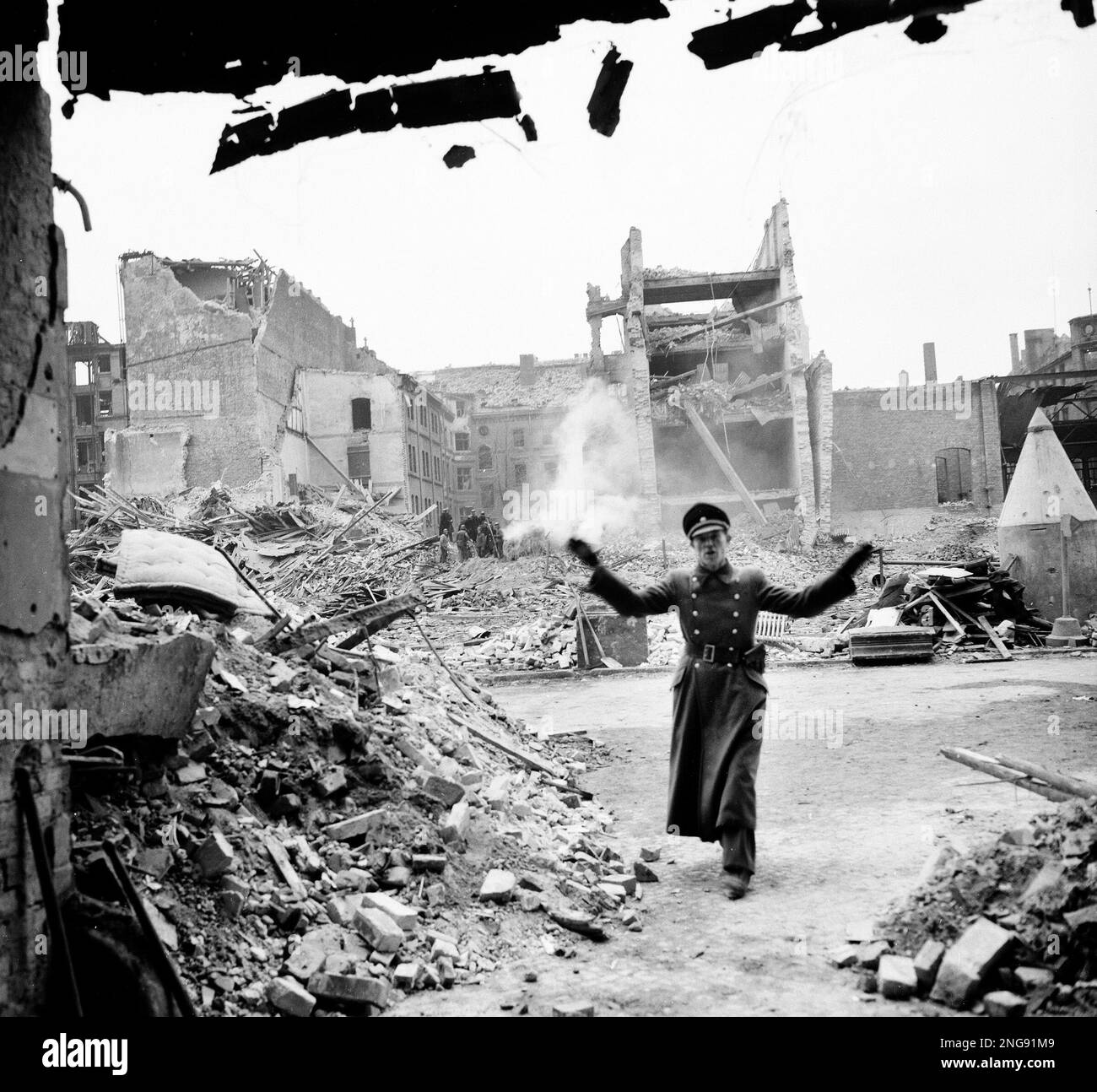 A policeman approaches the photographer waving his arms and shouting ...