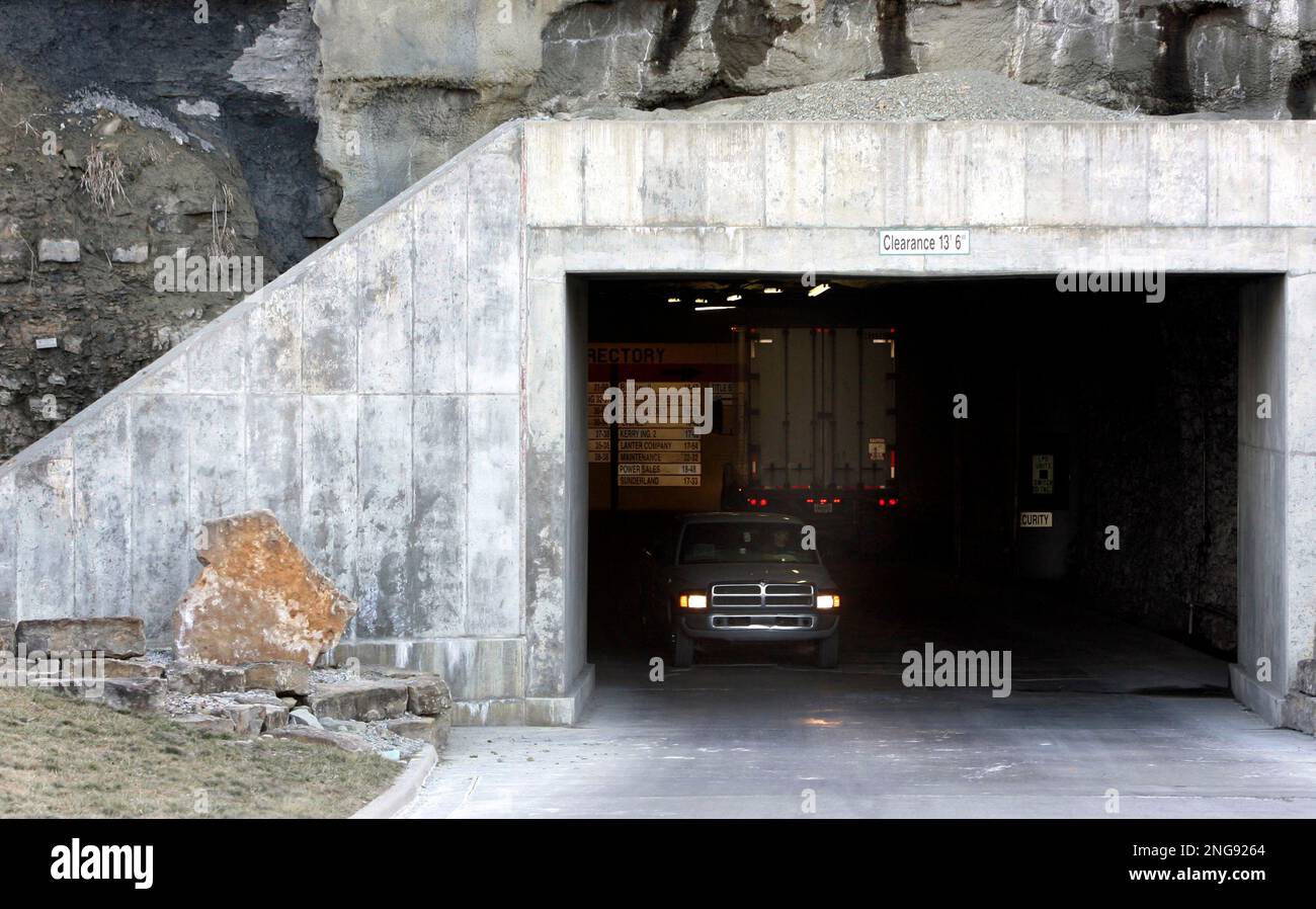 Trucks enter and exit the limestone cave entrance to the American ...