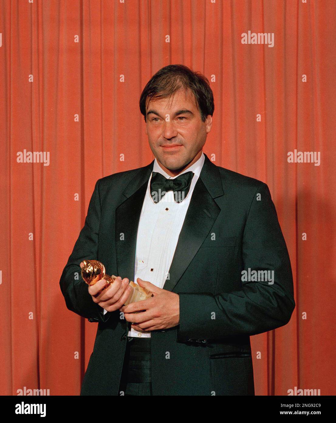 "Platoon" director Oliver Stone holds the Golden Globe for best ...