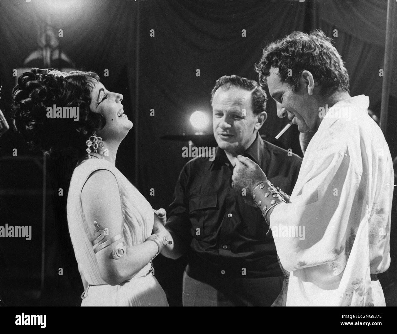 Actress Elizabeth Burton has a laugh as actor Richard Burton, right ...