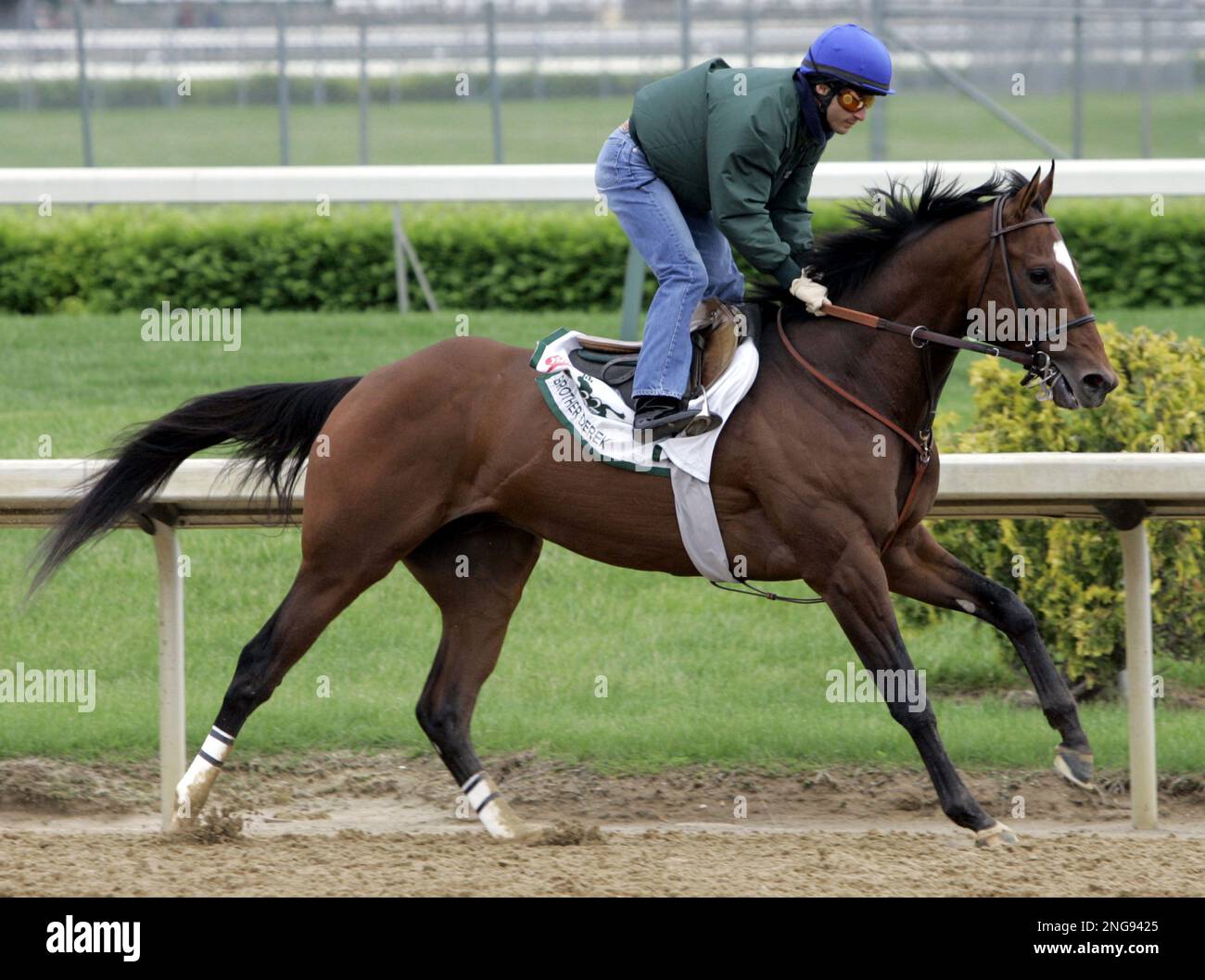 Kentucky Derby hopeful Brother Derek is ridden around the track by ...