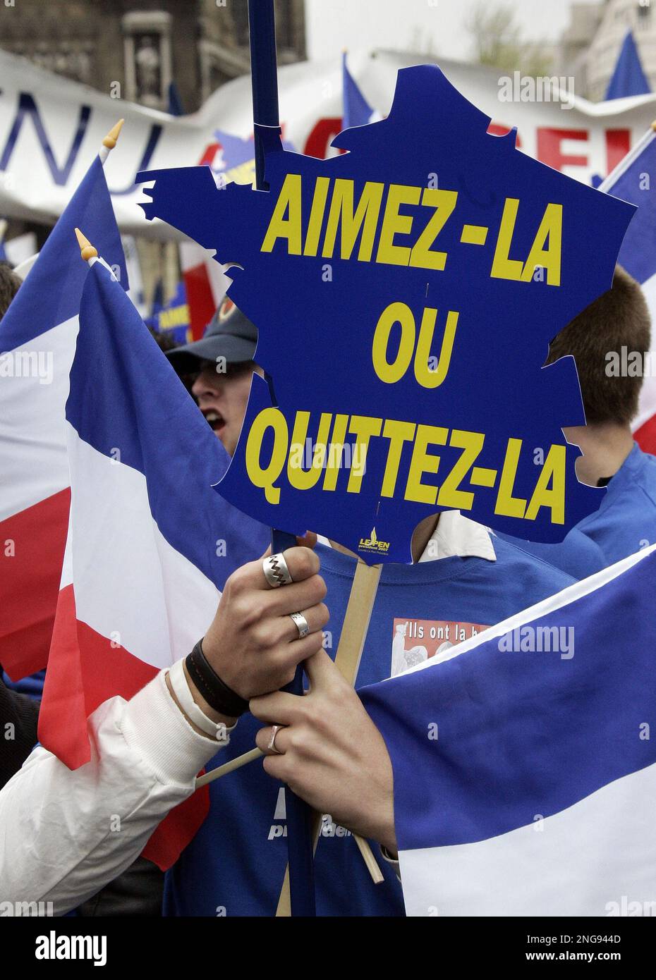 A militant of the French far-right National Front party holds a placard ...
