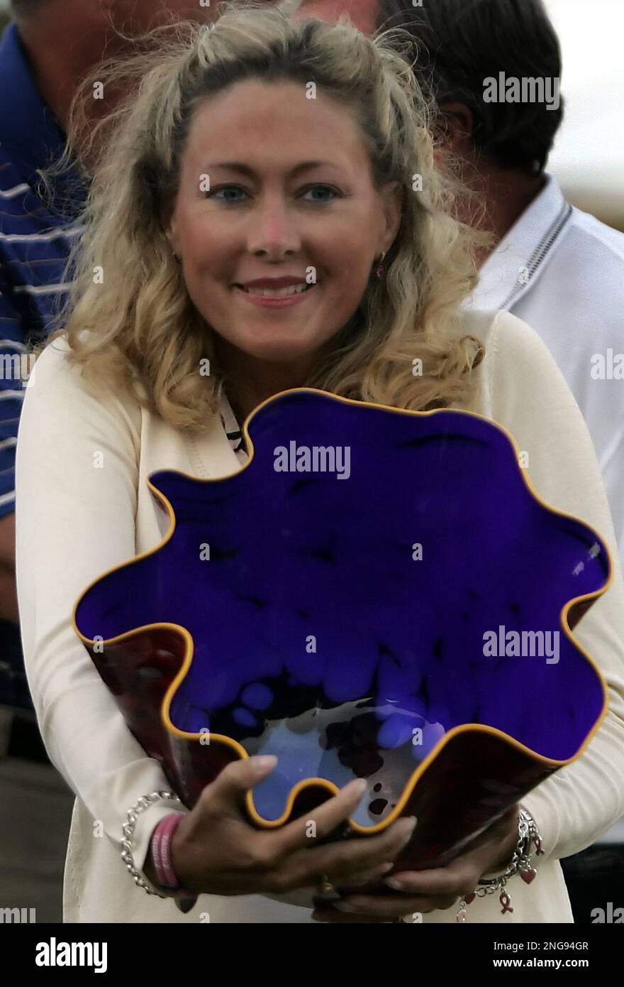 Kelly Jo Dowd holds a trophy that was given to the Dowd family after ...