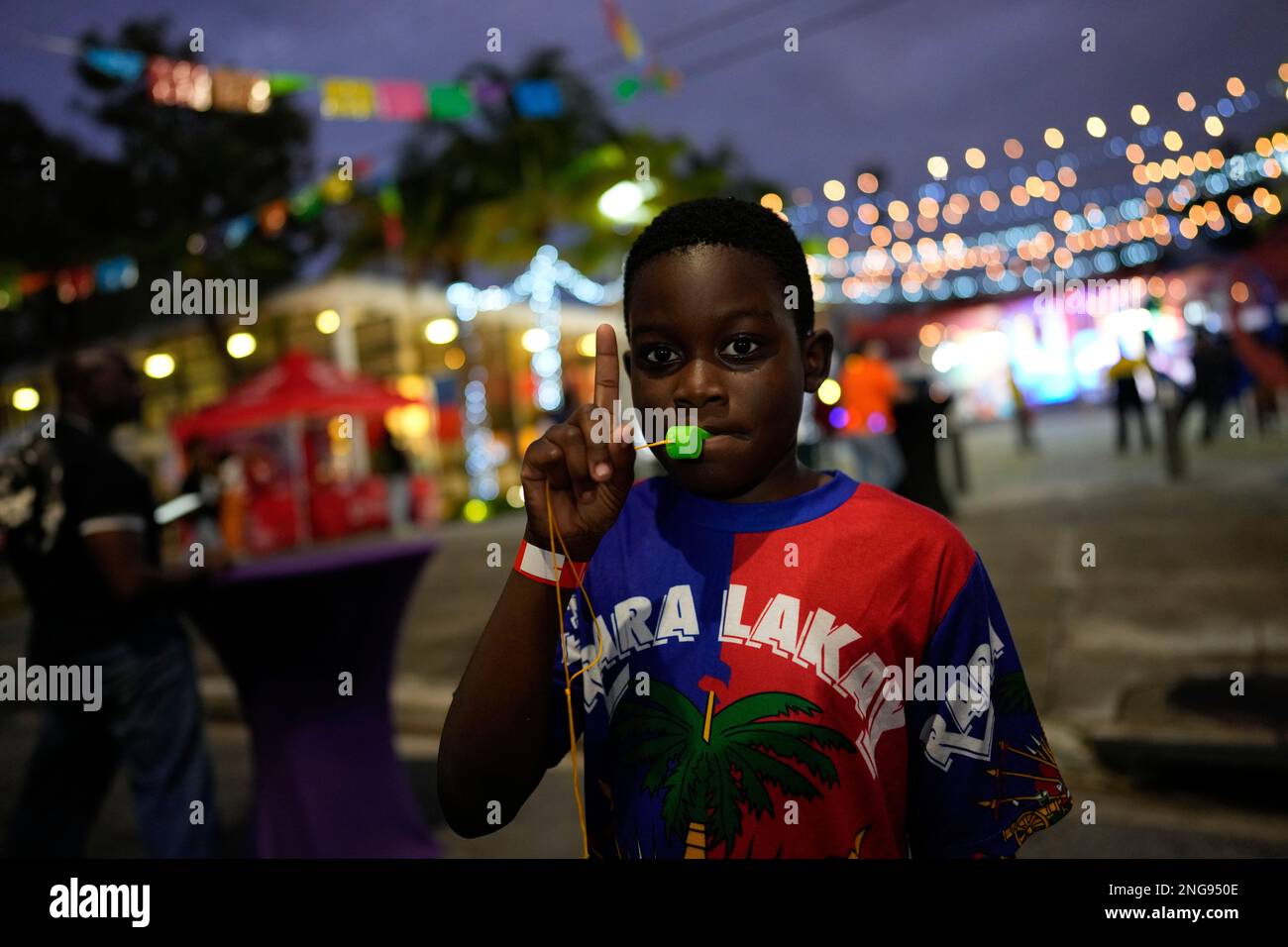 Kamari Alexis, 11, of Haitian descent, strikes a pose as he arrives for ...