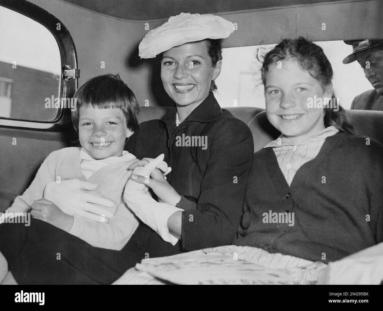 Film actress Rita Hayworth, center, leaves London Airport with her ...