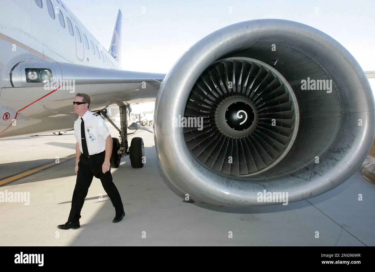Continental pilot Peter Cook inspects a plane before takoff at ...