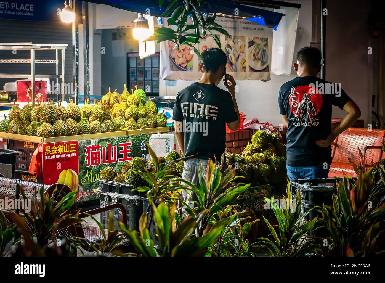Customers buying durians at durian store located at housing estate in ...