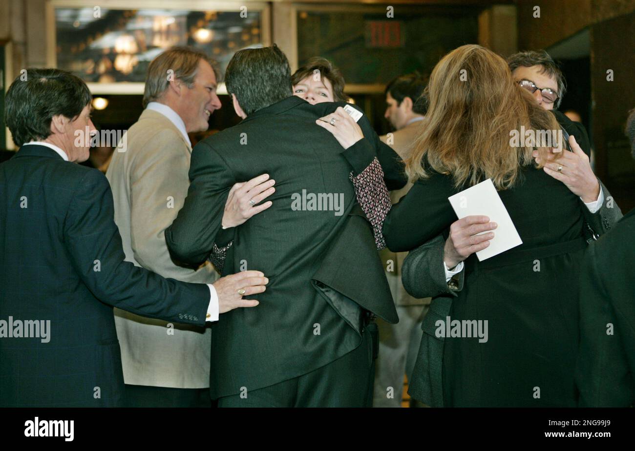 Mourners embrace outside the New Amsterdam Theater, Monday, April 10 ...