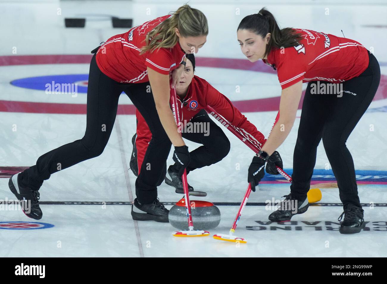 Team Canada skip Kerri Einarson, back, watches as lead Briane Harris ...