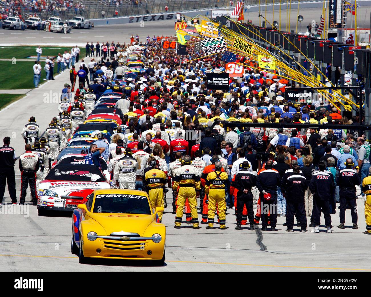 NASCAR crews stand for the national anthem prior to the start of the O'Reilly 300 auto race at ...