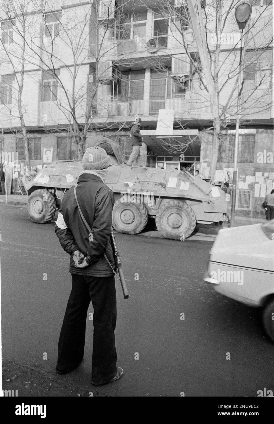 Armed Iranian Fedayeen revolutionaries stand guard near a captured ...