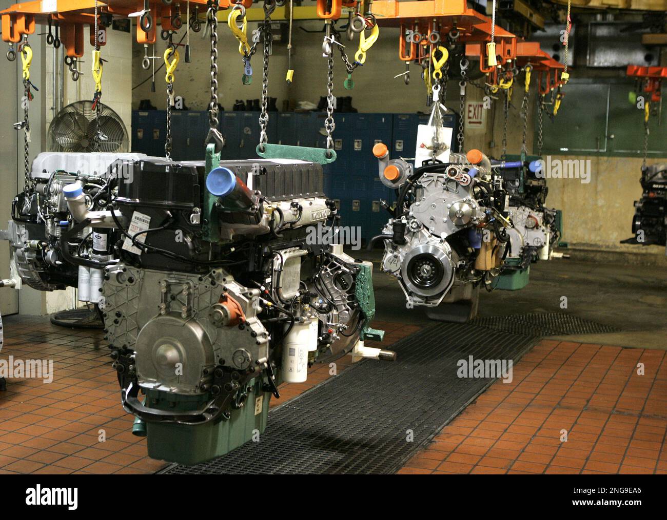 A row of Volvo diesel truck engines are supported by chains as they ...