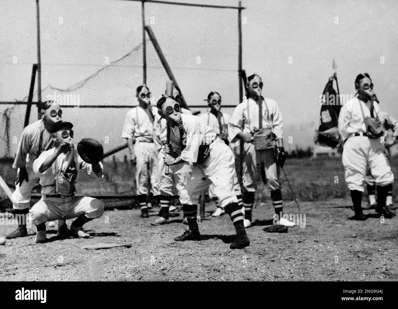 Ball players are seen playing while wearing gas masks, Sept. 3, 1938 in ...