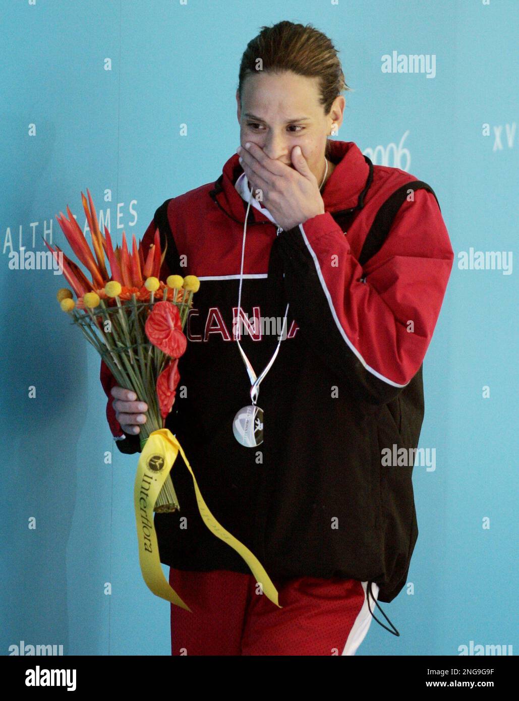 Canada's Anne Polinario shows emotion after being presented with the ...