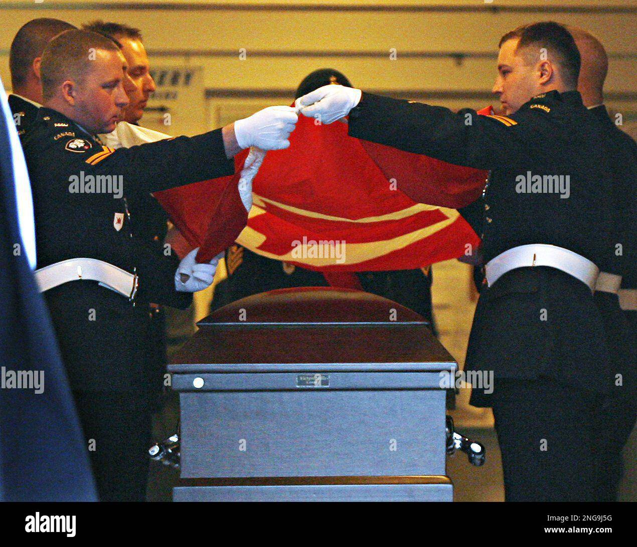 The Canadian flag is folded as the coffin of Cpl. Paul Davis is ...