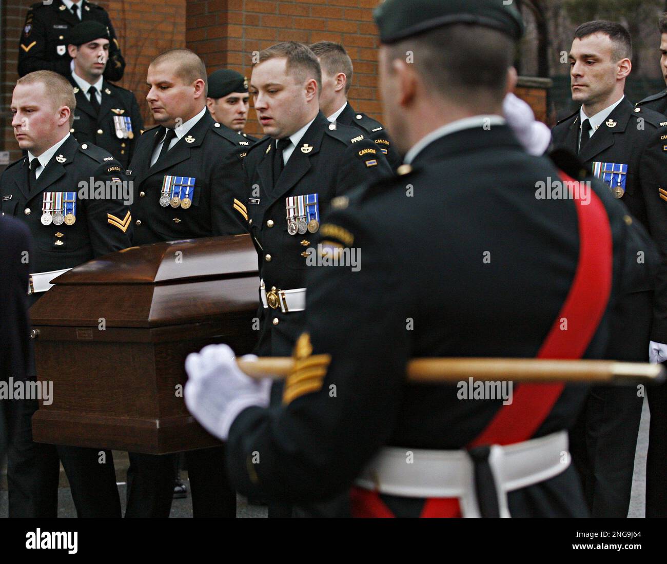 The body of Cpl. Paul Davis is carried from Knox United Church by ...