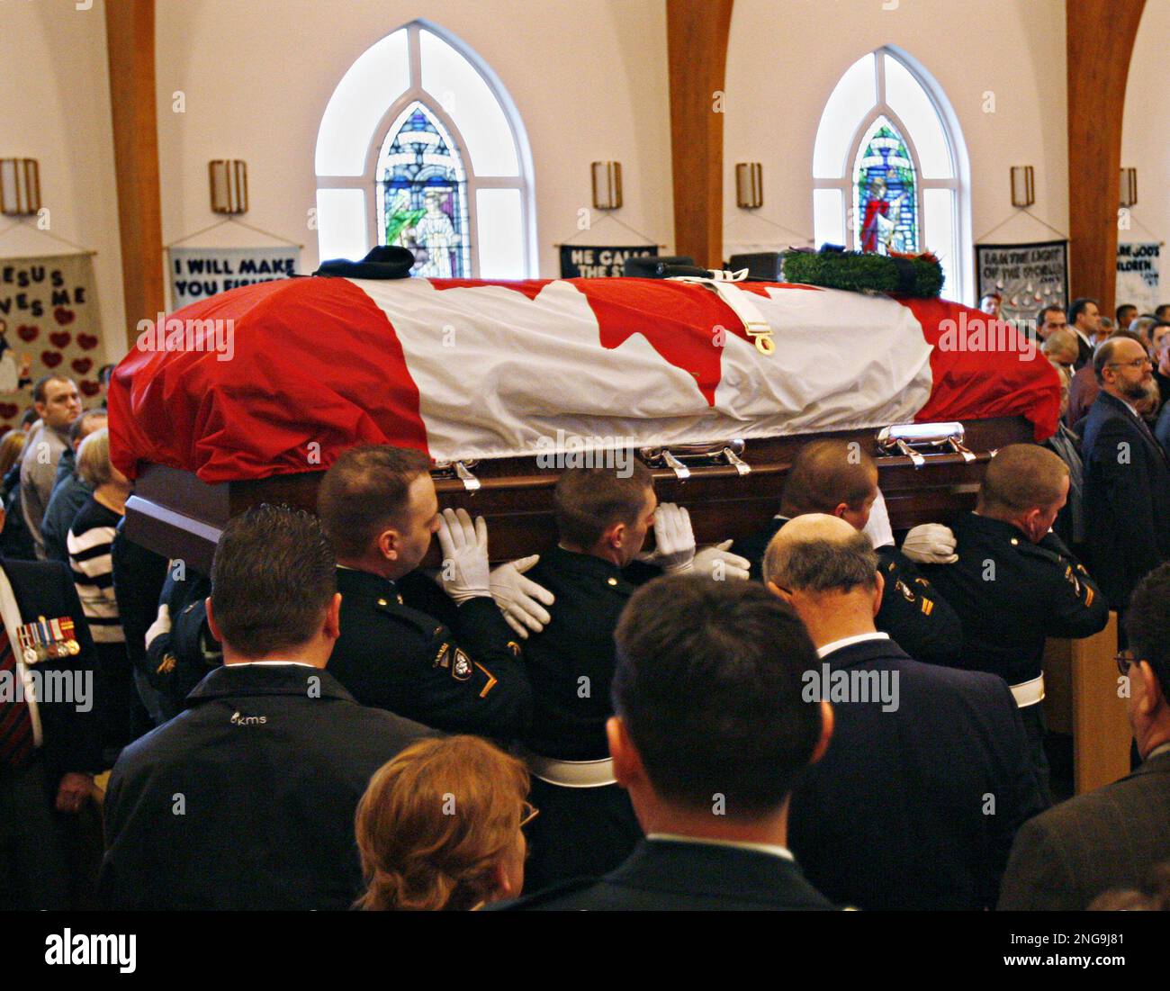 The body of Cpl. Paul Davis is carried into Knox United Church by ...