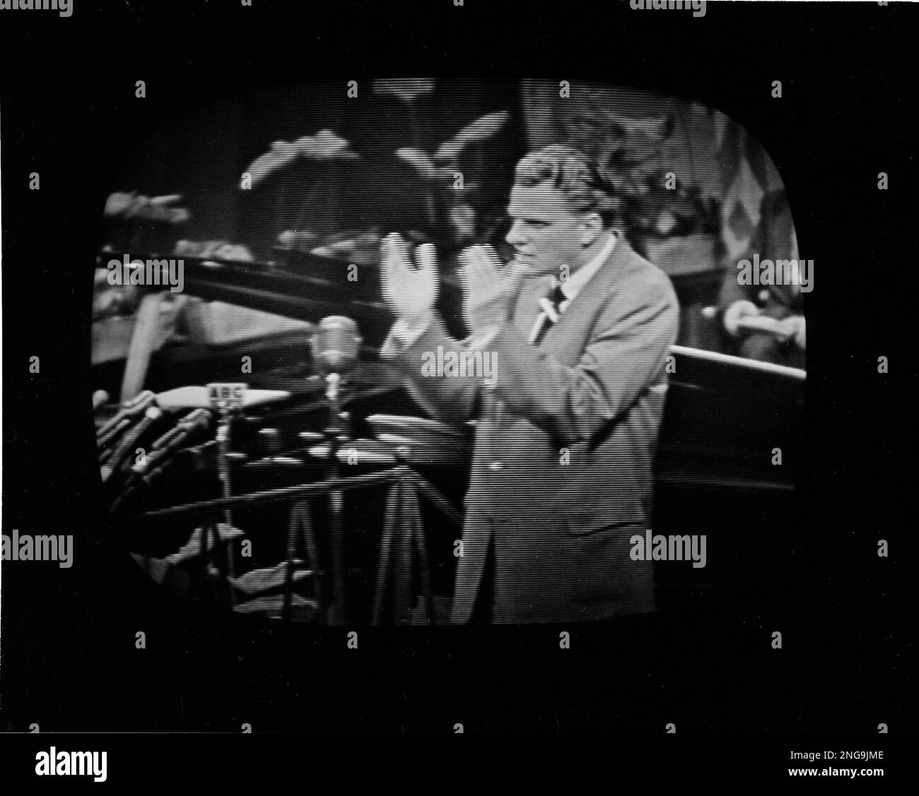 The Rev. Billy Graham appears on a television screen during a live ...